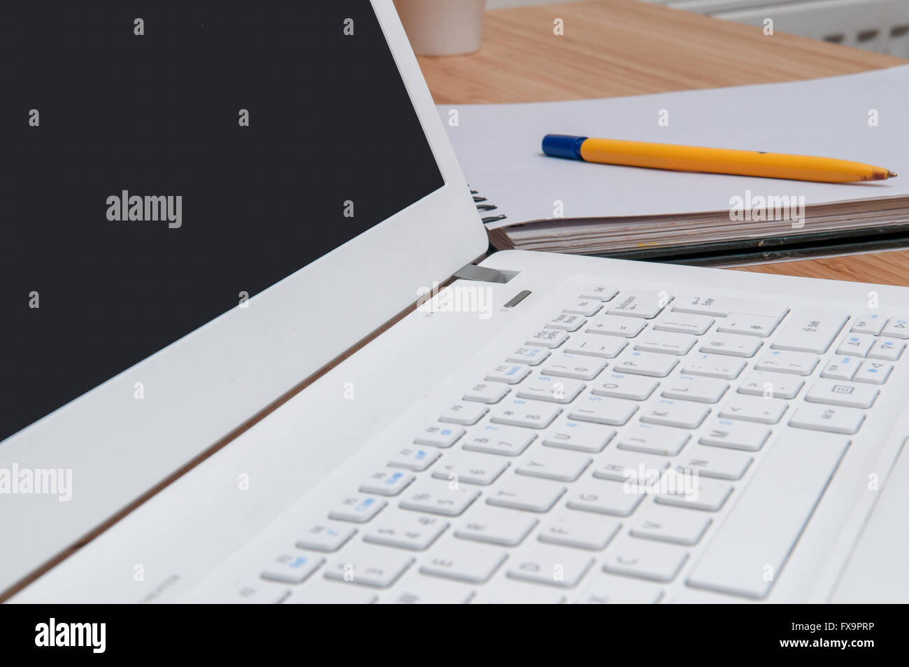 Laptop and notepad on the table with blank screen and pages Stock Photo ...