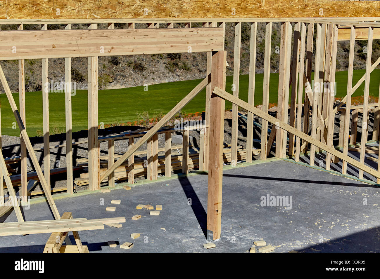 Construction ladders chained to wood framed wall of new construction ...