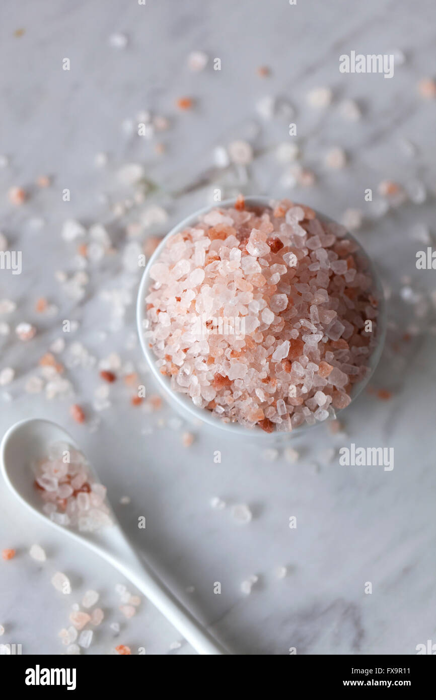 Pink Himalayan salt in the small white bowl and white marble surface ...