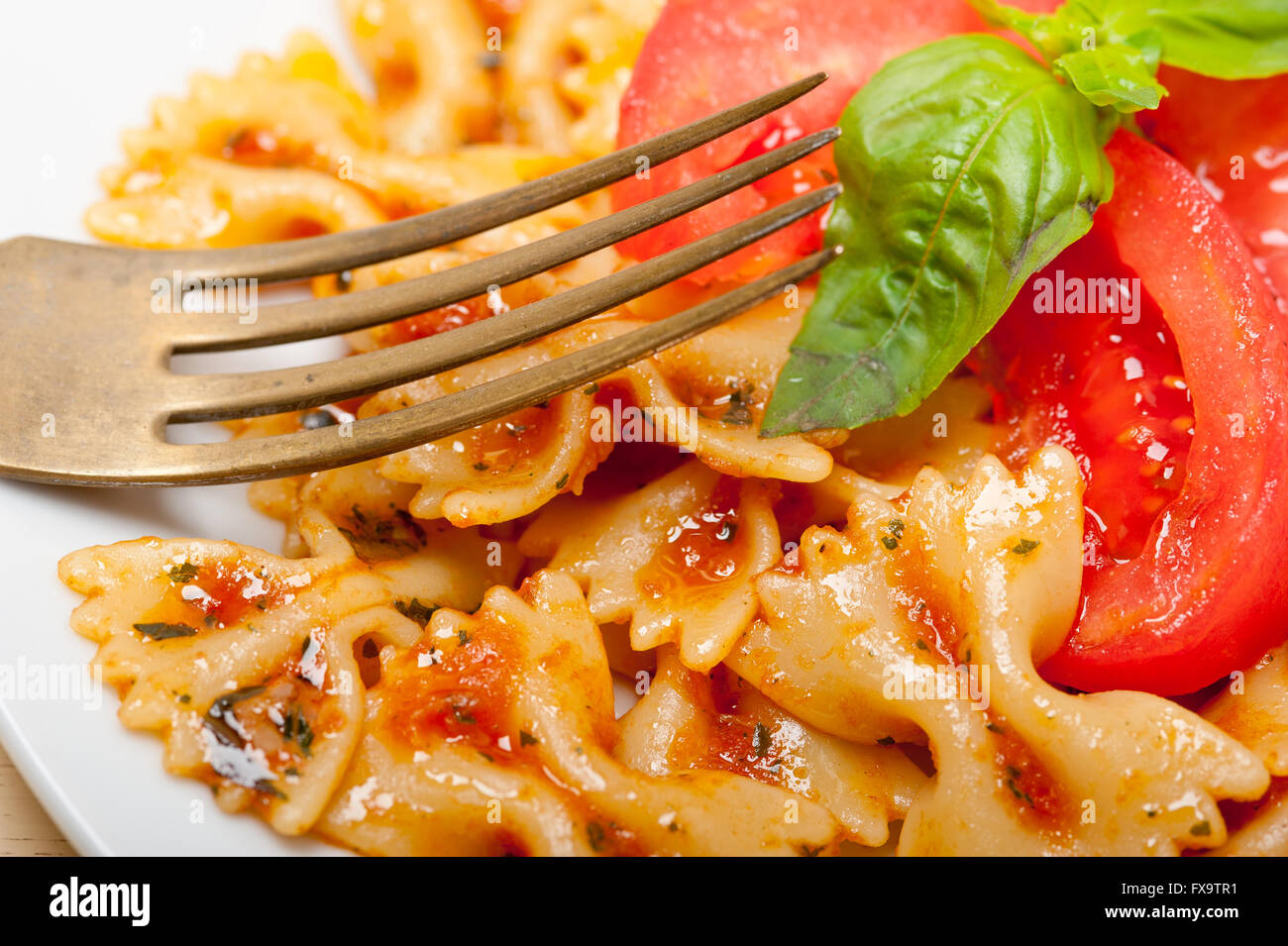 Italian pasta farfalle butterfly bow-tie with tomato basil sauce over ...
