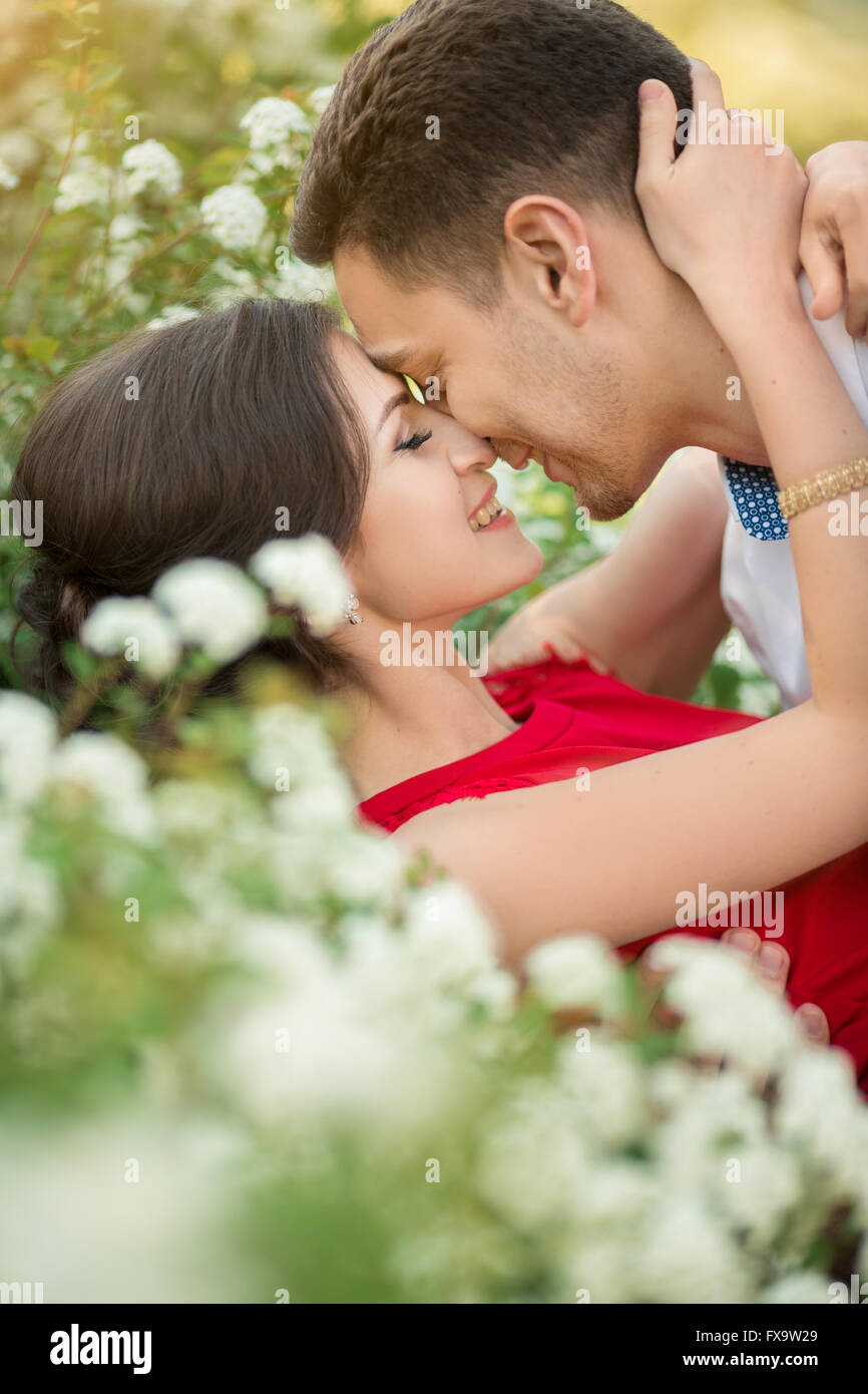 Young man kissing woman in park 20 24 years hi-res stock photography and images - Alamy