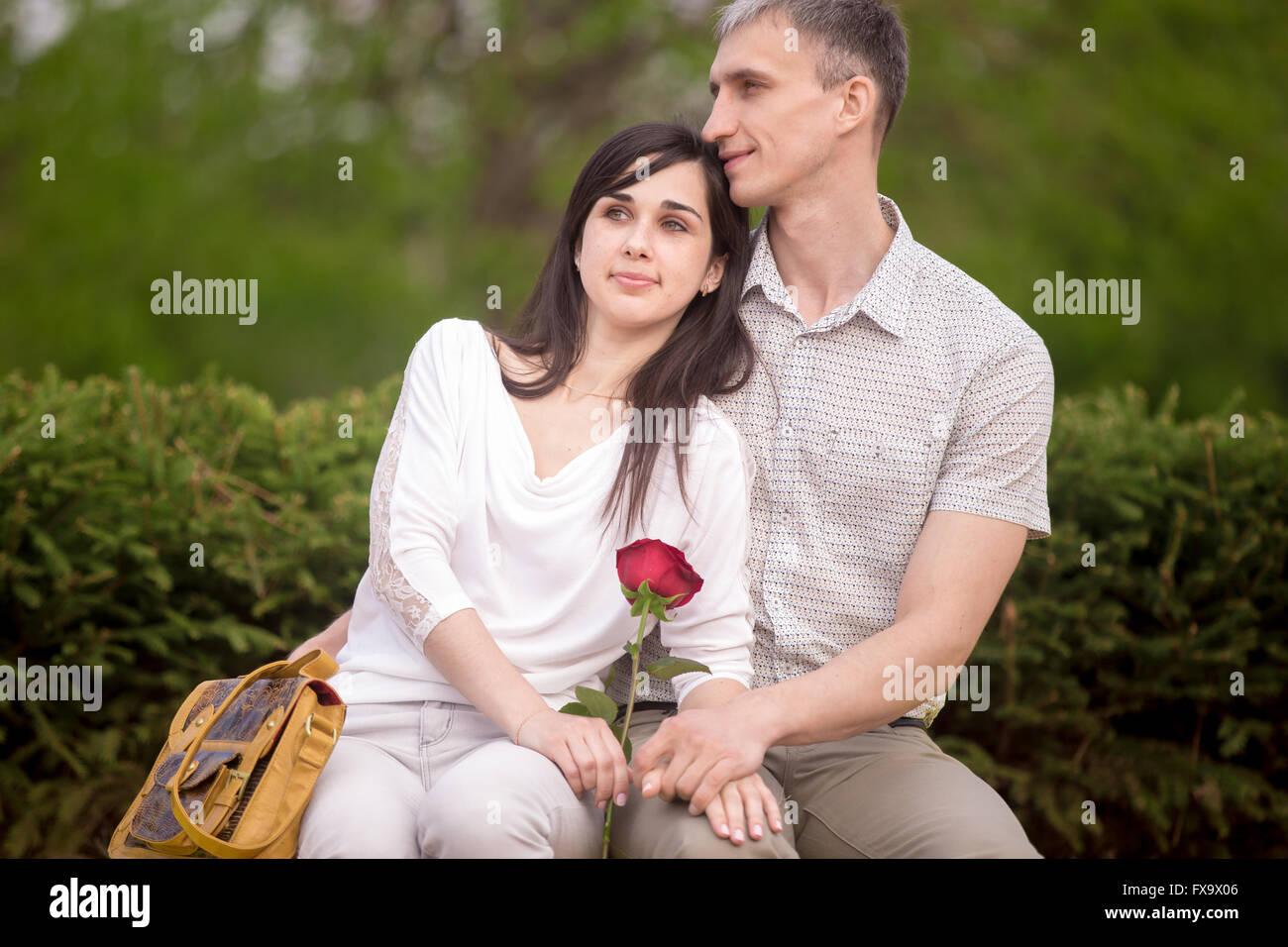 Couple sitting on a wooden park bench hi-res stock photography and ...