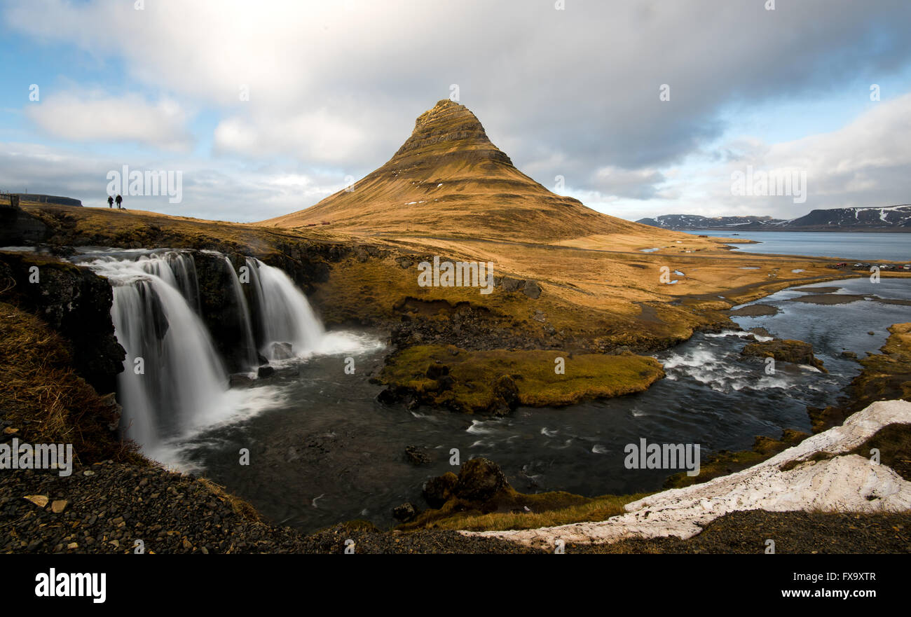 Kirkjufellsfoss waterfalls with the Kirkjufell mountain , at ...