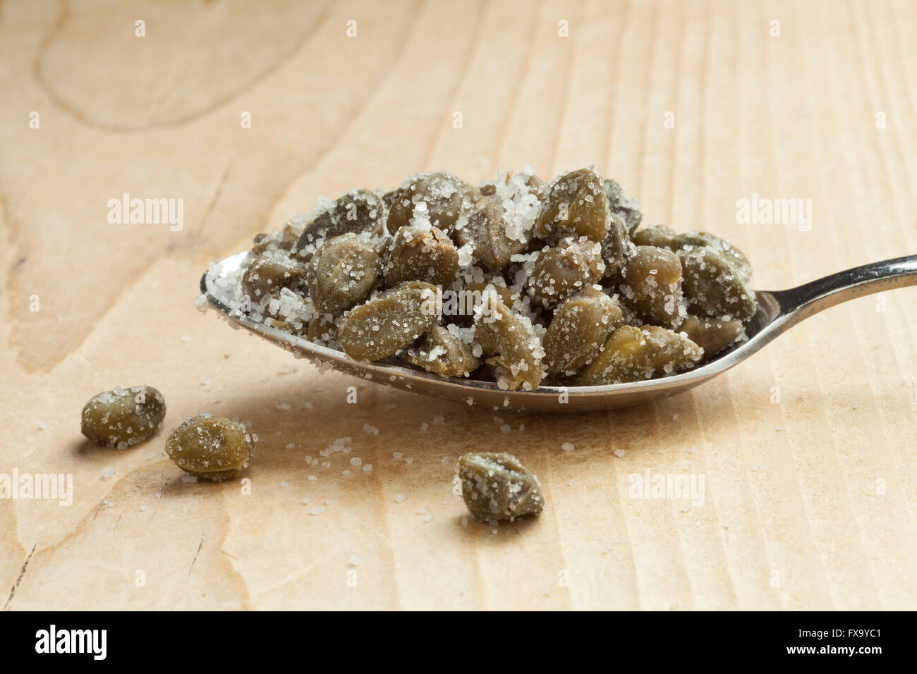 Salted capers on a spoon Stock Photo - Alamy