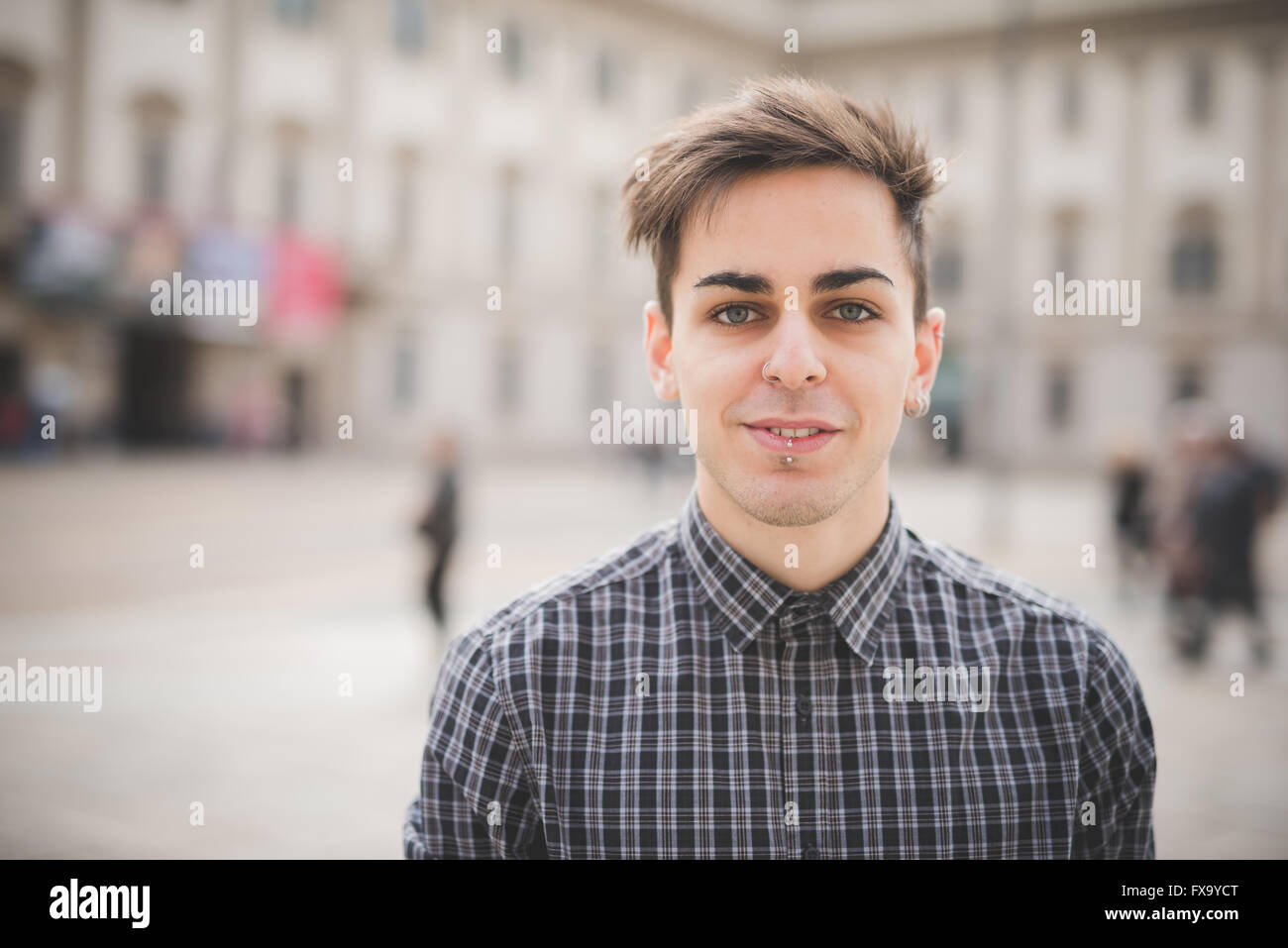 Portrait of young handsome alternative dark model man in town, looking ...