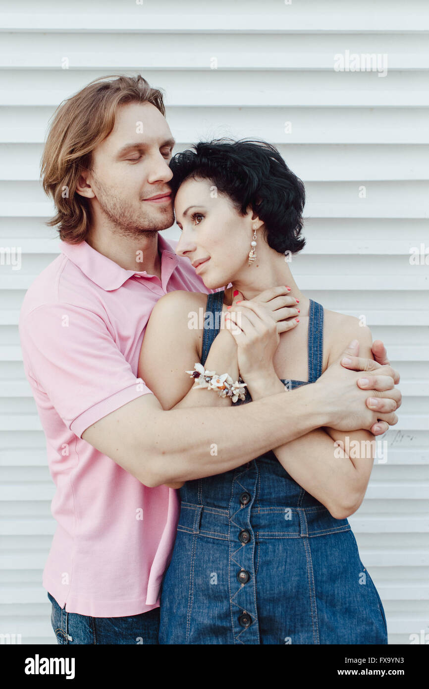Couple cuddling on a light background Stock Photo - Alamy