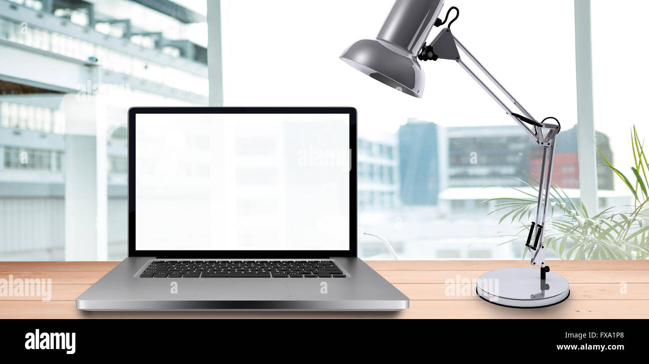 Composite image of desk with laptop Stock Photo - Alamy