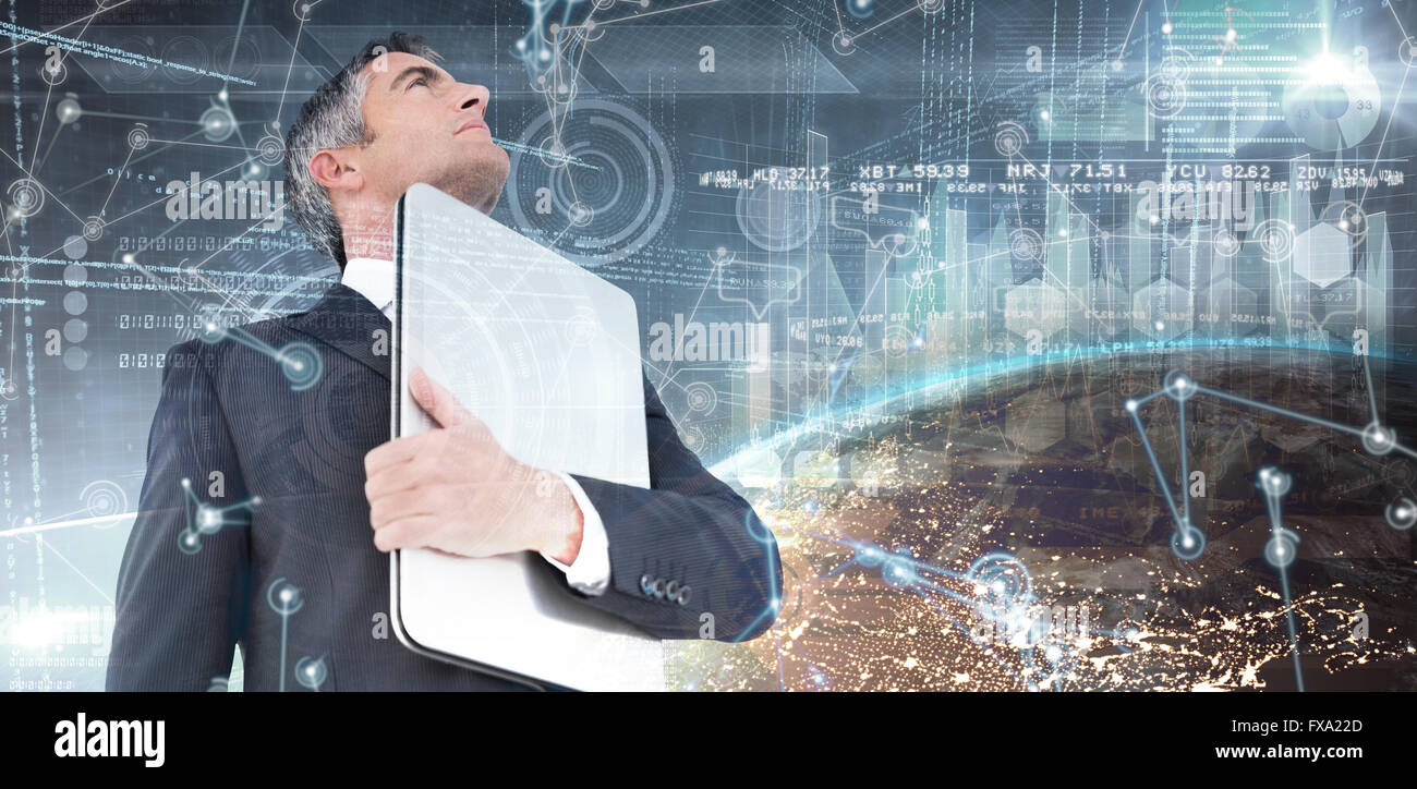 Composite image of businessman in suit holding his laptop proudly Stock ...