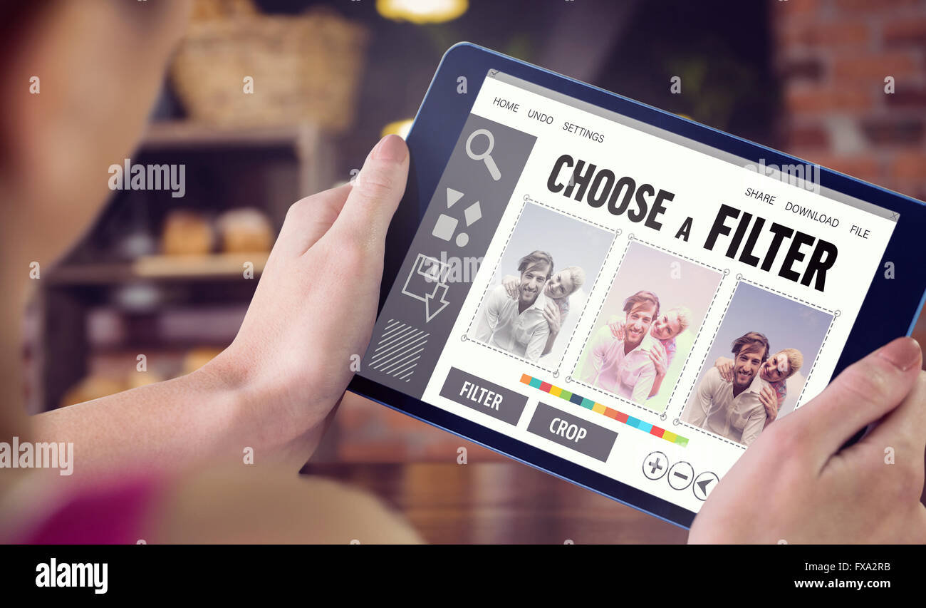 Composite image of woman using tablet pc Stock Photo - Alamy