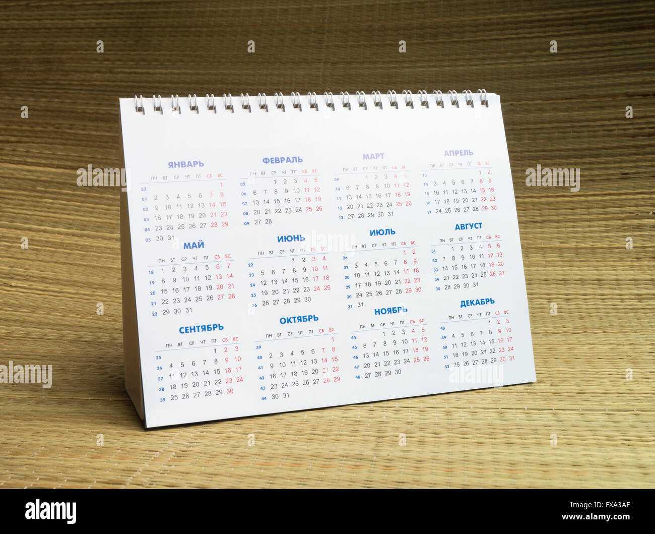 Desk paper calendar with number and letter from white paper on beige ...