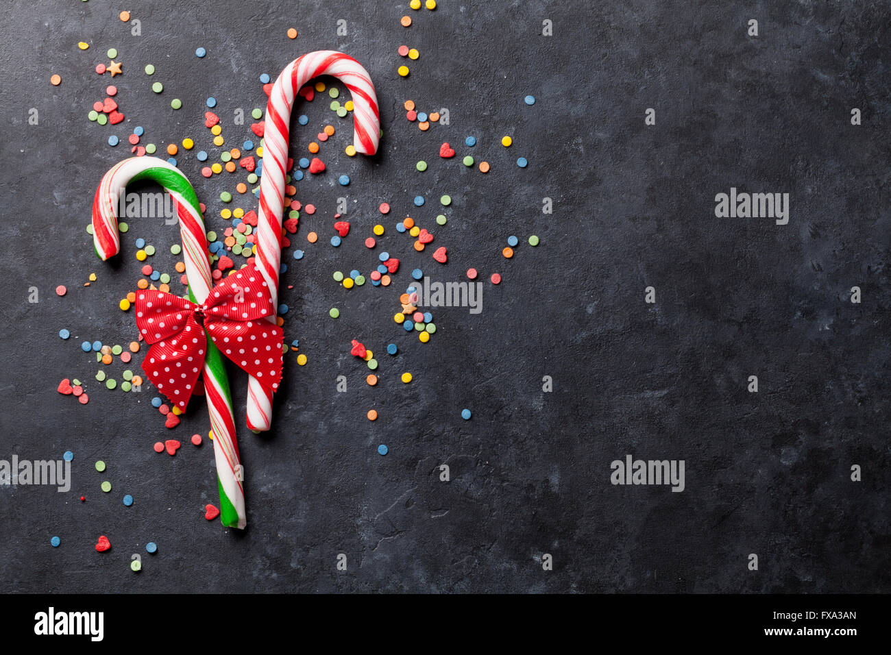 Candy canes over stone background. Top view with copy space Stock Photo ...