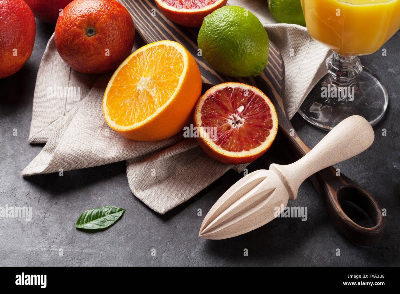 Fresh ripe citruses. Lemons, limes and oranges on dark stone background ...
