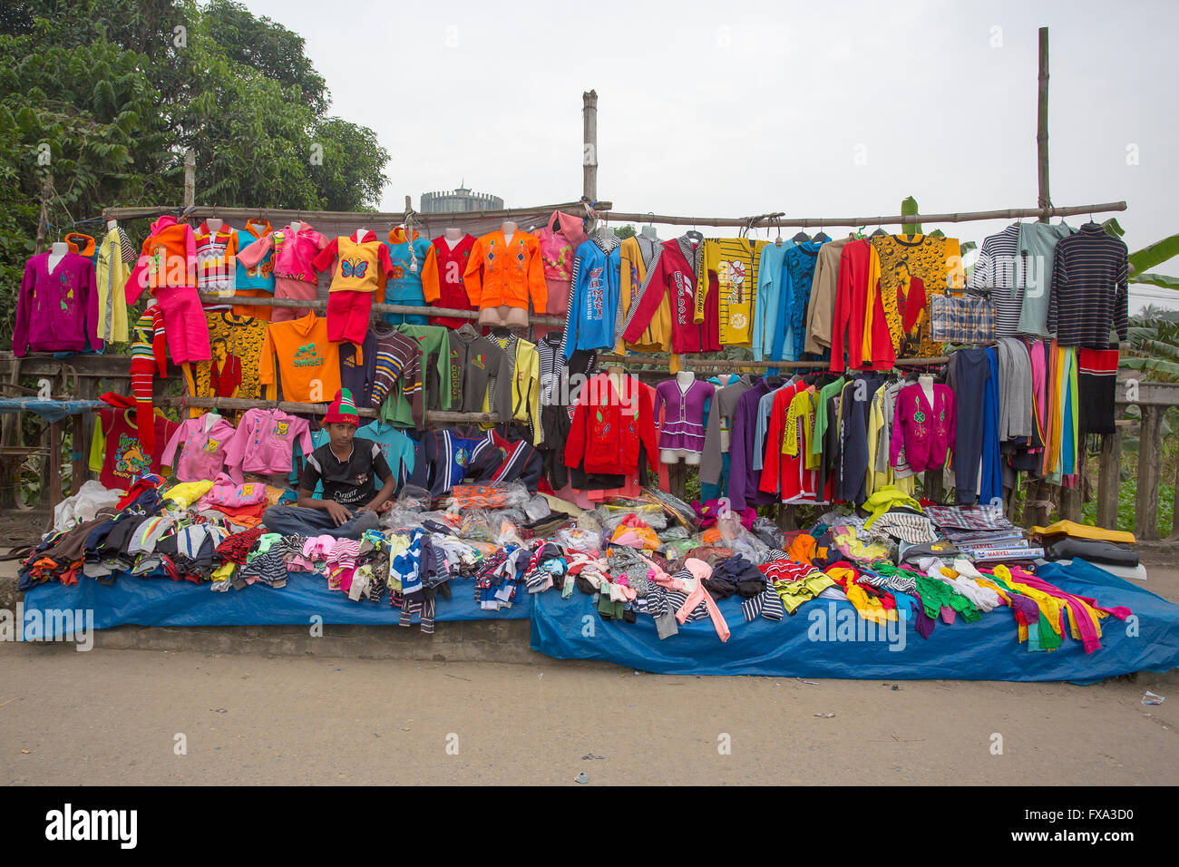 An old man selling pumpkin flowers (kumro ful) in street side of Dhaka ...