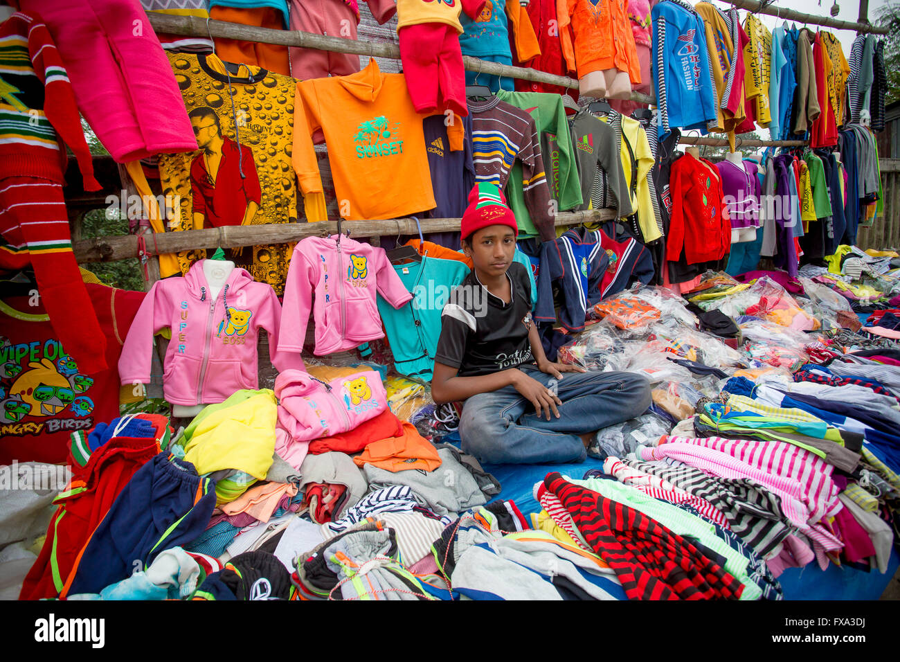 An old man selling pumpkin flowers (kumro ful) in street side of Dhaka ...