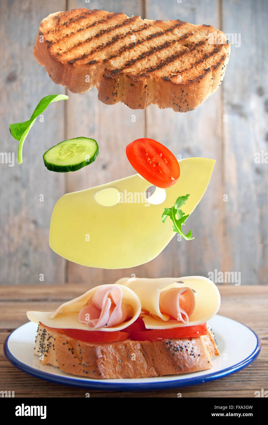 Sandwich ingredients falling into place onto a plate Stock Photo - Alamy