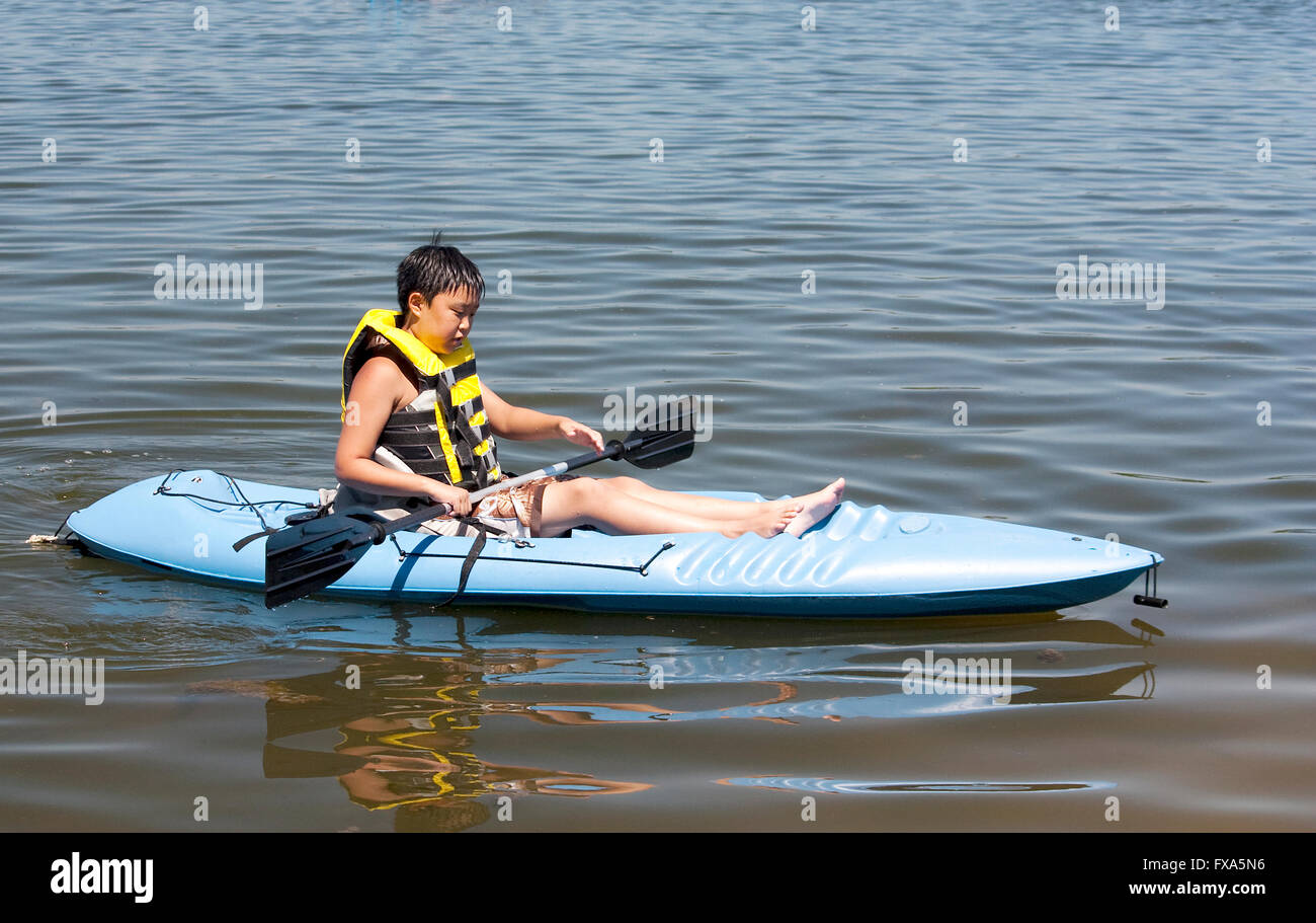 A young Korean boy in a Kayak on a lake Stock Photo - Alamy