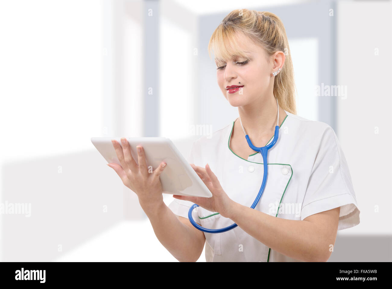 a beautiful nurse holding and using a digital tablet Stock Photo - Alamy