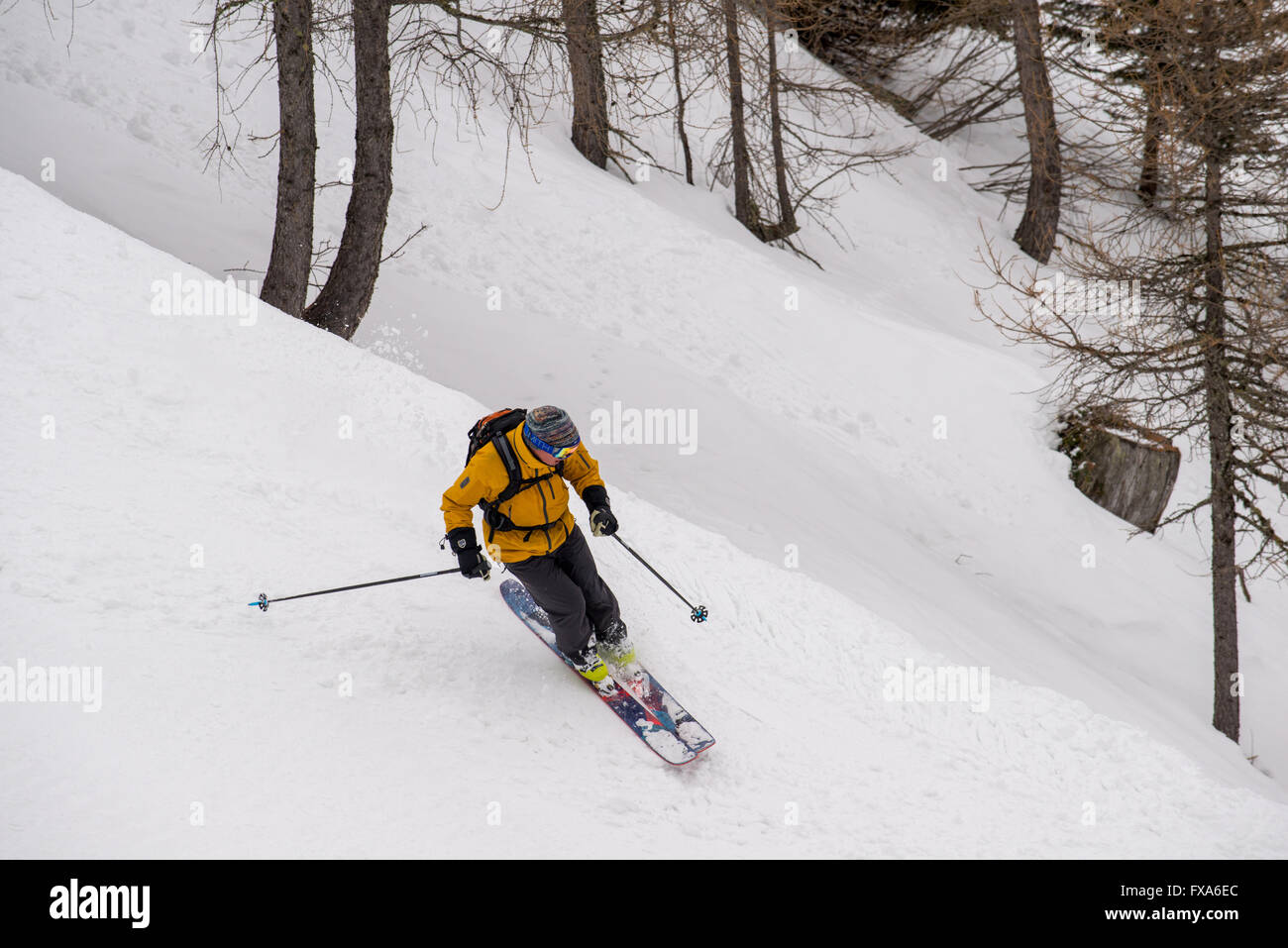 Skier doing good parallel turn down red run Stock Photo - Alamy