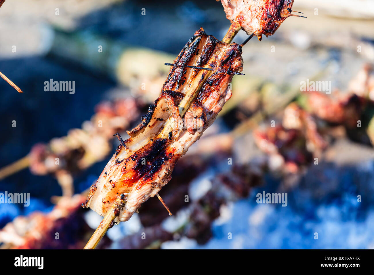 Grilling meat with barbecue stuff Stock Photo - Alamy