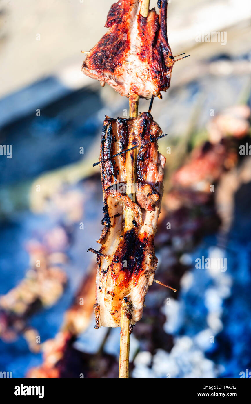 Grilling meat with barbecue stuff Stock Photo - Alamy