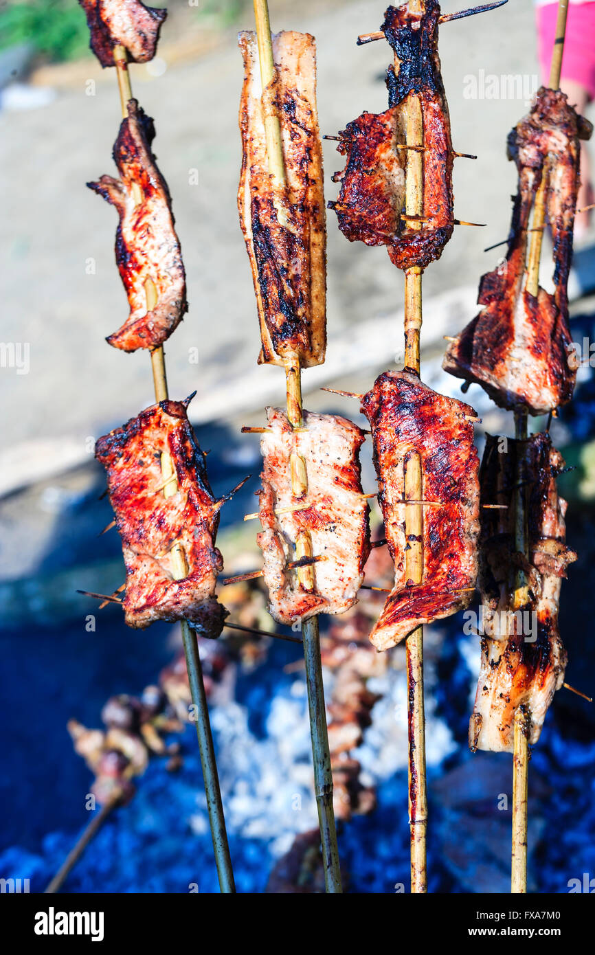 Grilling meat with barbecue stuff Stock Photo - Alamy