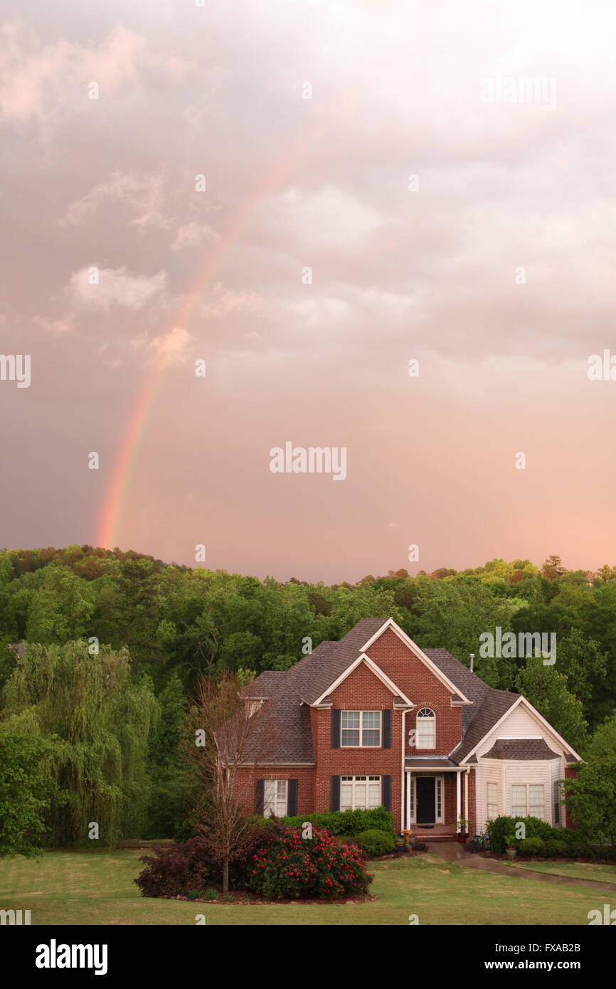 Rainbow above a house Stock Photo - Alamy