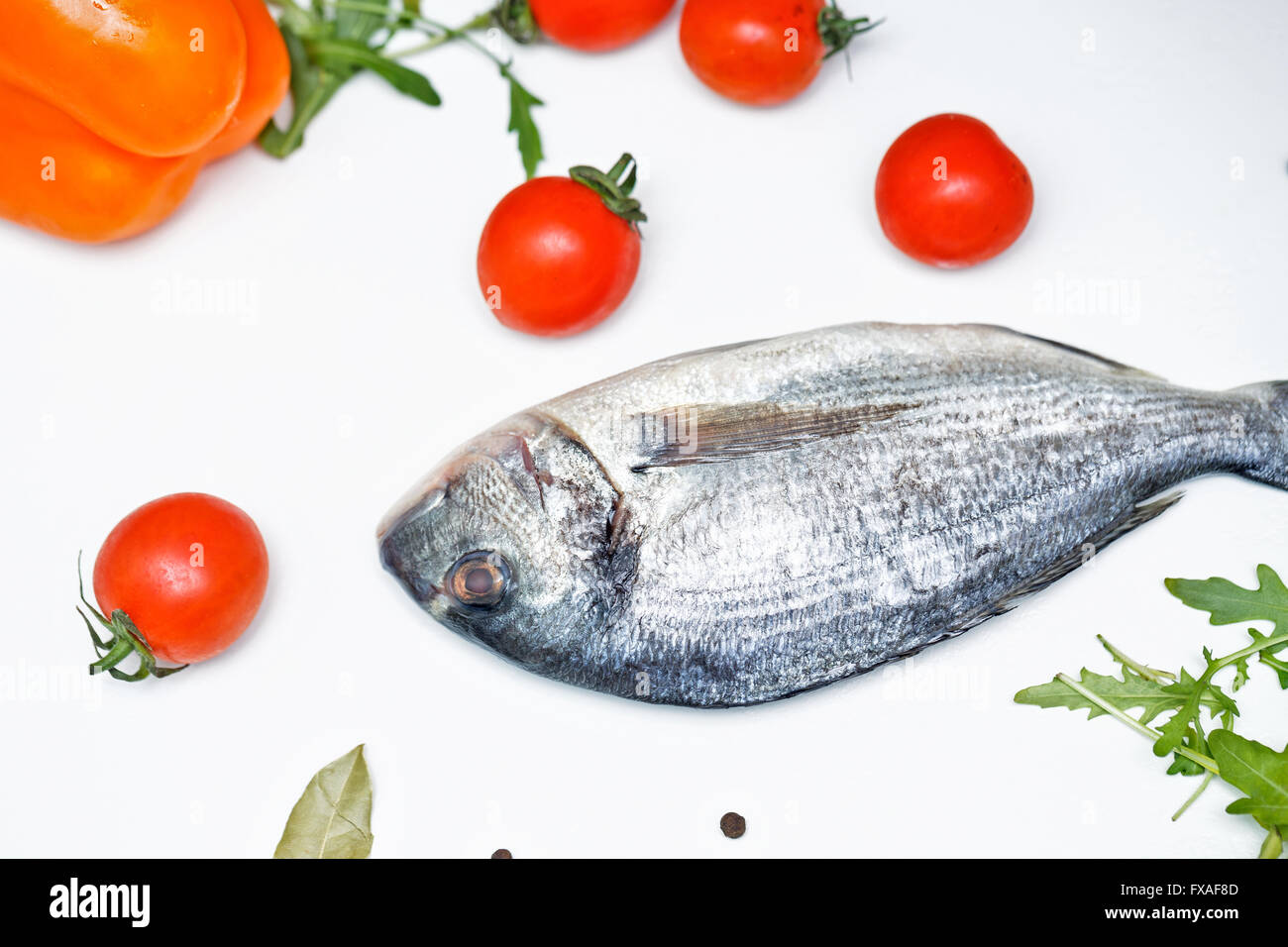 Still life. Ripe vegetables and fish lying on the kitchen table. Dinner ...