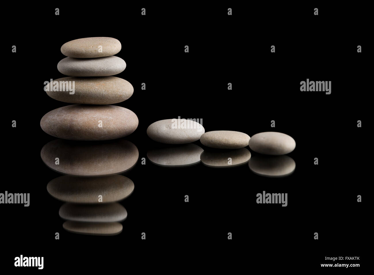 Pile of balancing pebble stones, like ZEN stone, on black background ...