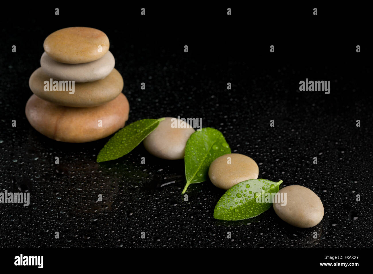 Pile of balancing pebble stones and green leaf with water drop, ZEN ...