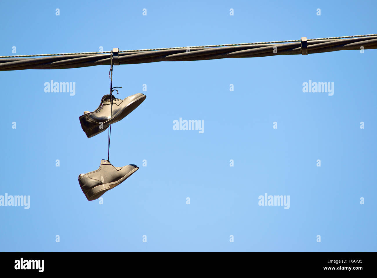 Shoes hanging from cable hi-res stock photography and images - Alamy