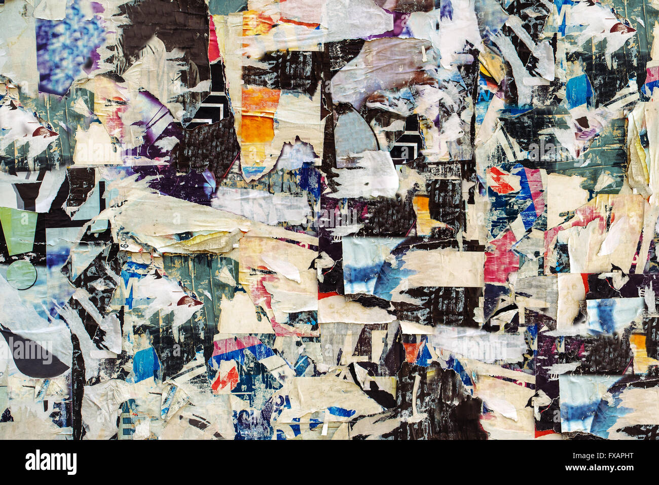 Advertising posters paper scraps on wall as urban background, torn ...