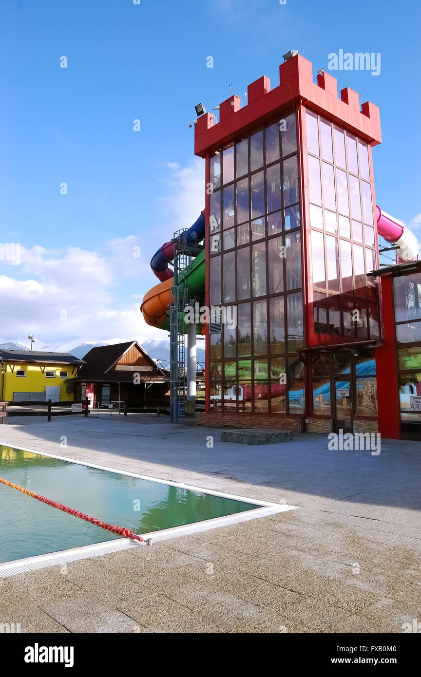 LIPTOVSKY MIKULAS, SLOVAKIA. Red tower and big swimming-pool with green ...