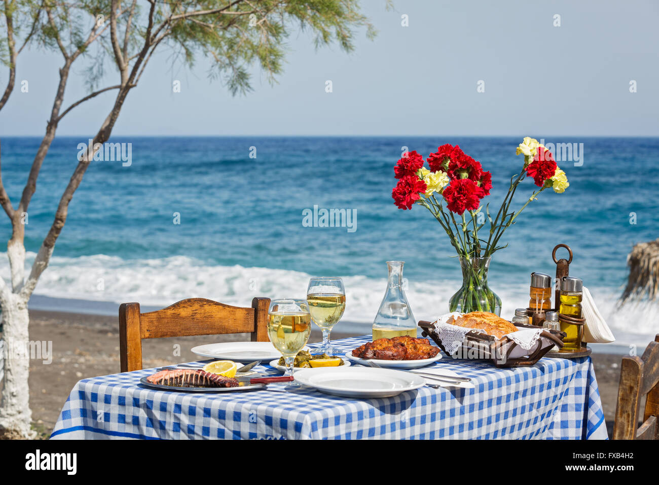 Beautiful romantic table for dinner on the sand beach, near the sea ...