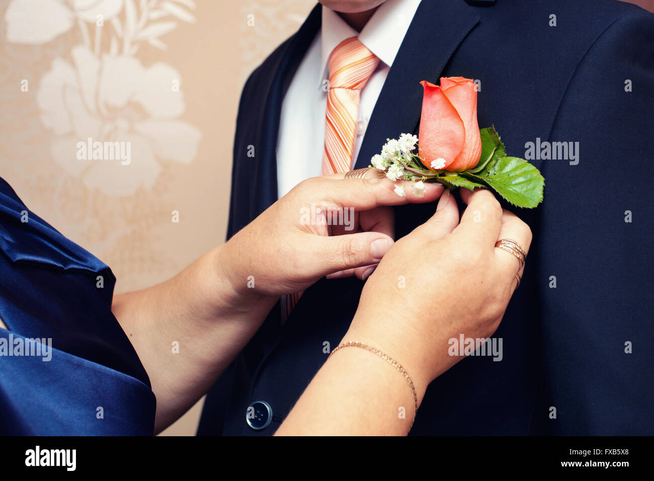 hands of mother correct a buttonhole for the groom Stock Photo - Alamy