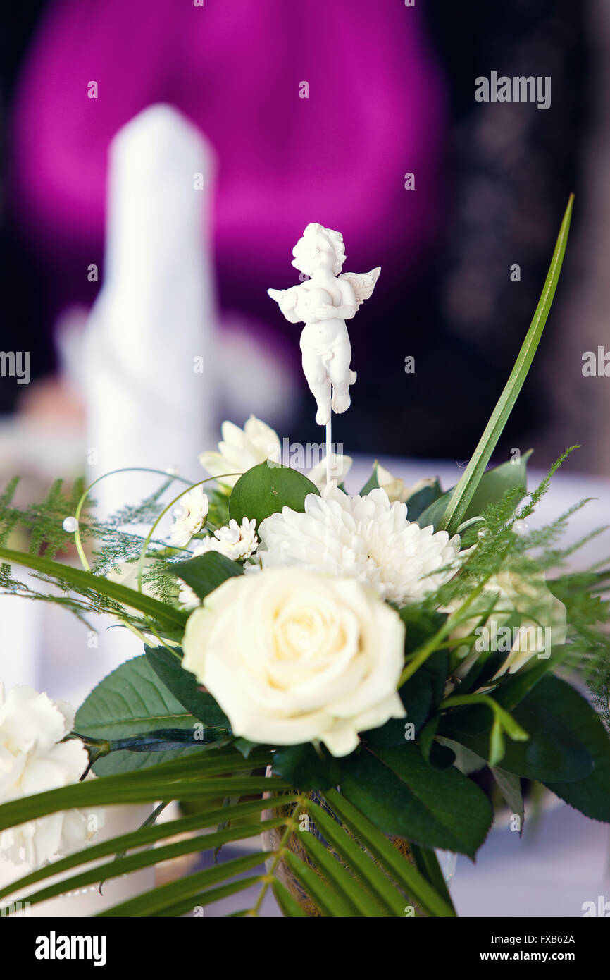 Angel statue with colorful flower Stock Photo - Alamy