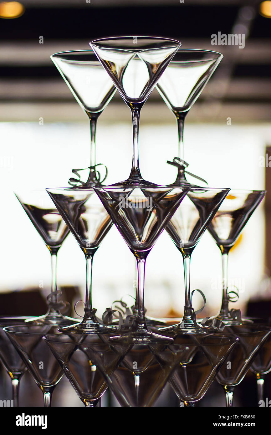 martini glasses in the form of a cascade or pyramid lit light at the wedding party Stock Photo ...