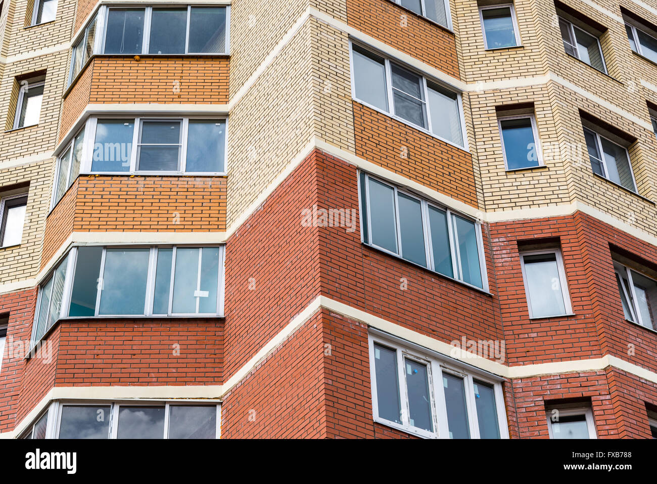 Modern high-rise apartment building made of brick Stock Photo - Alamy