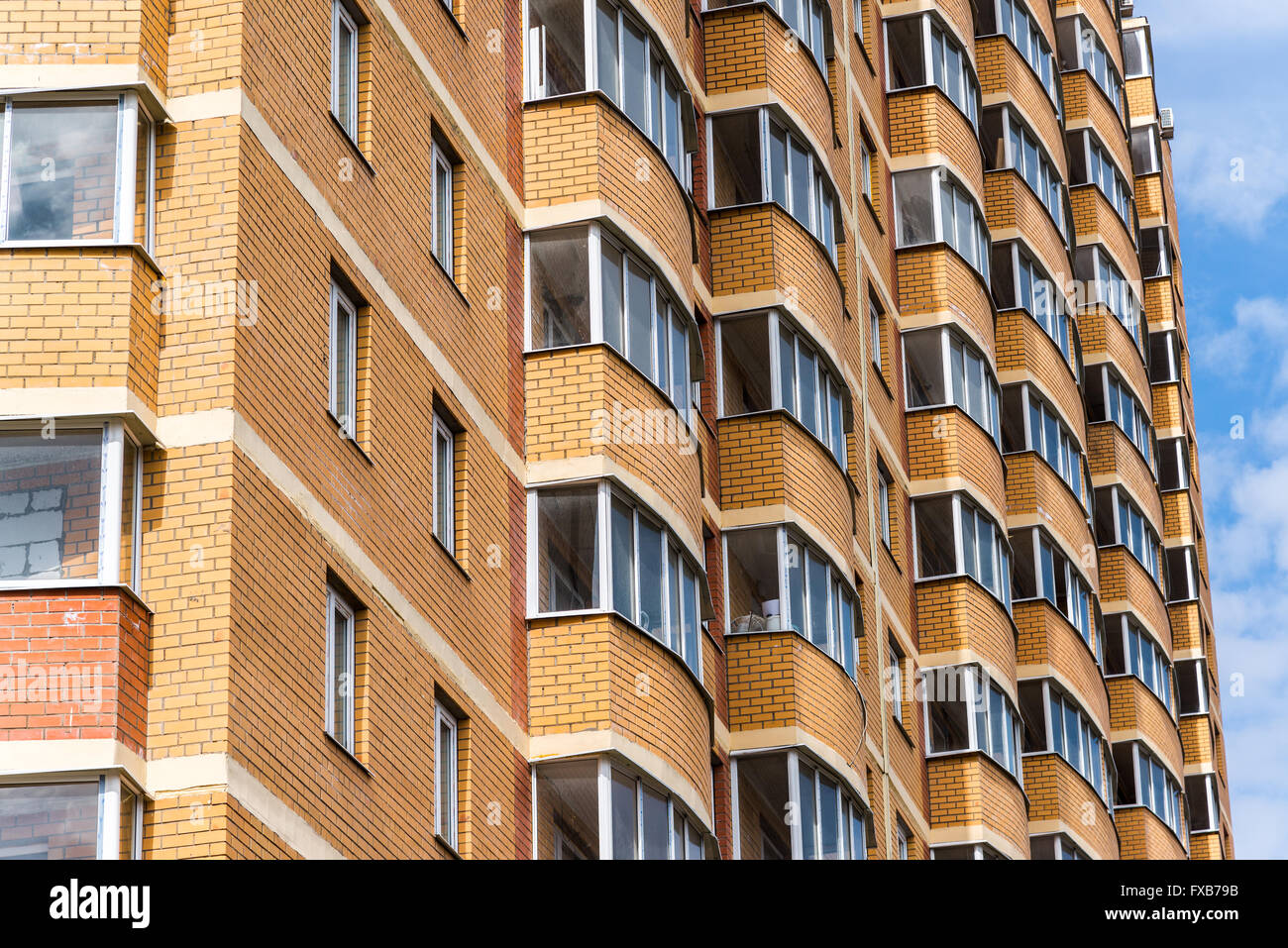 Modern high-rise apartment building made of brick Stock Photo - Alamy