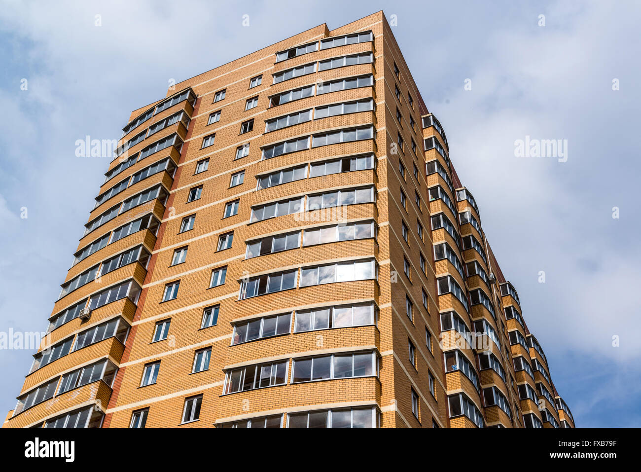 Modern high-rise apartment building made of brick Stock Photo - Alamy
