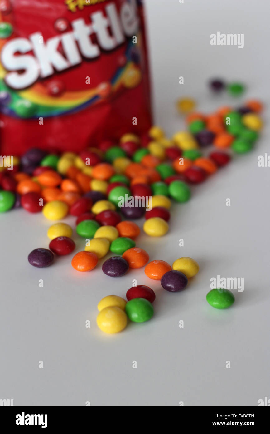 A colourful bag of skittles displayed on a white background Stock Photo ...
