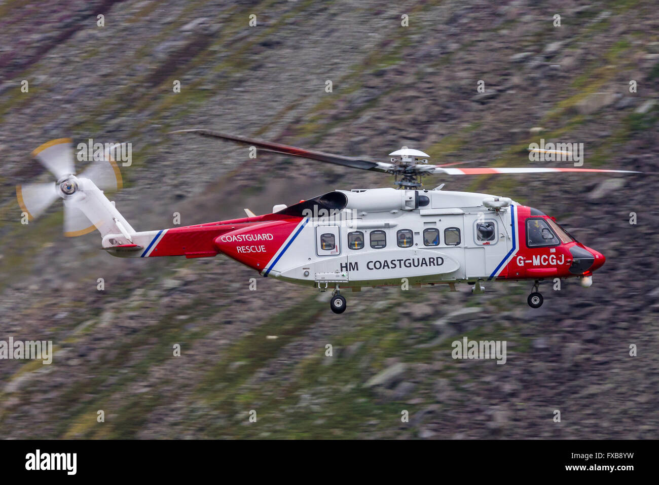 HM Coastguard helicopter operating in Snowdonia, North Wales Stock ...