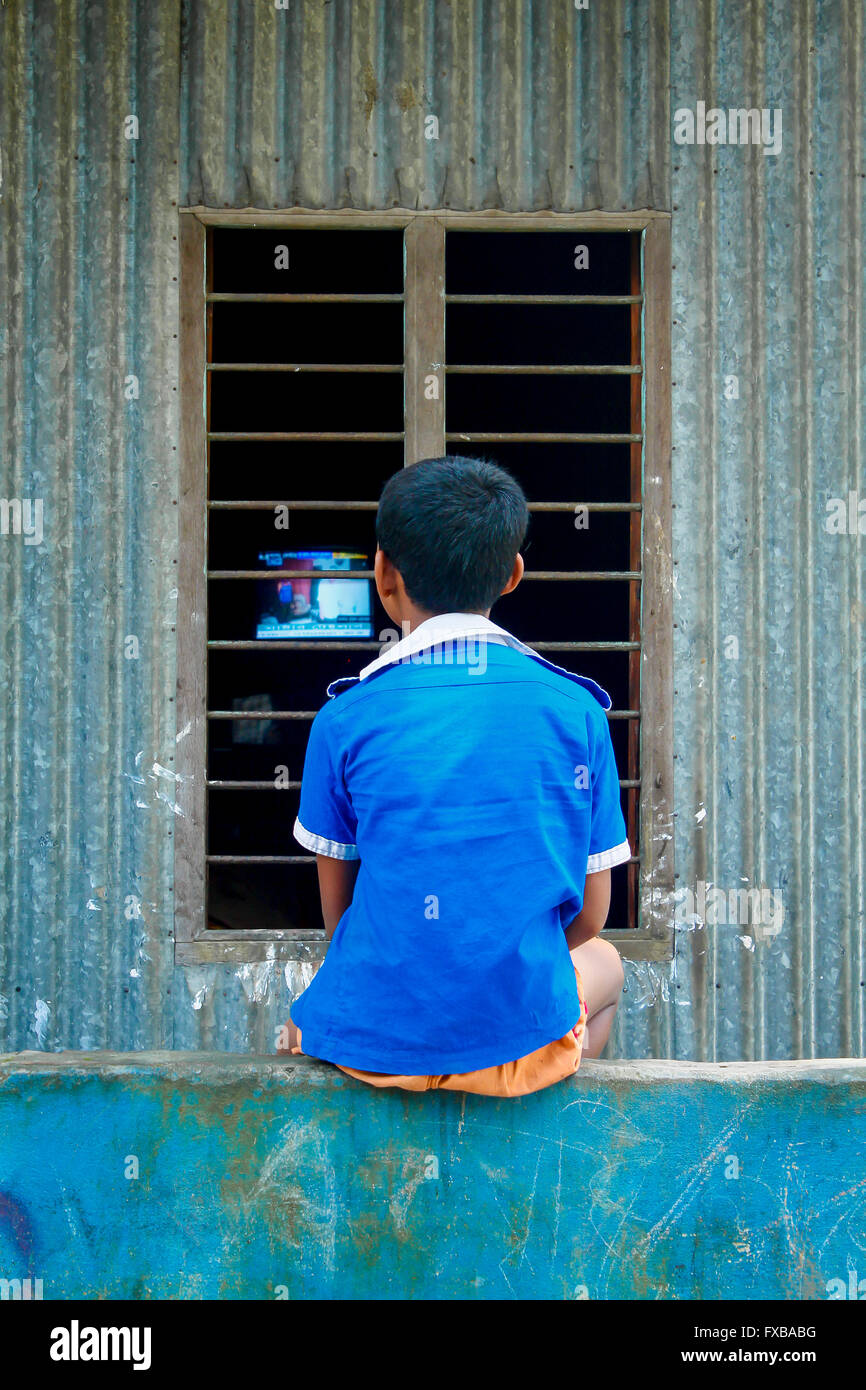 A boy watching television on window in dhaka, Bangladesh, Asia ...