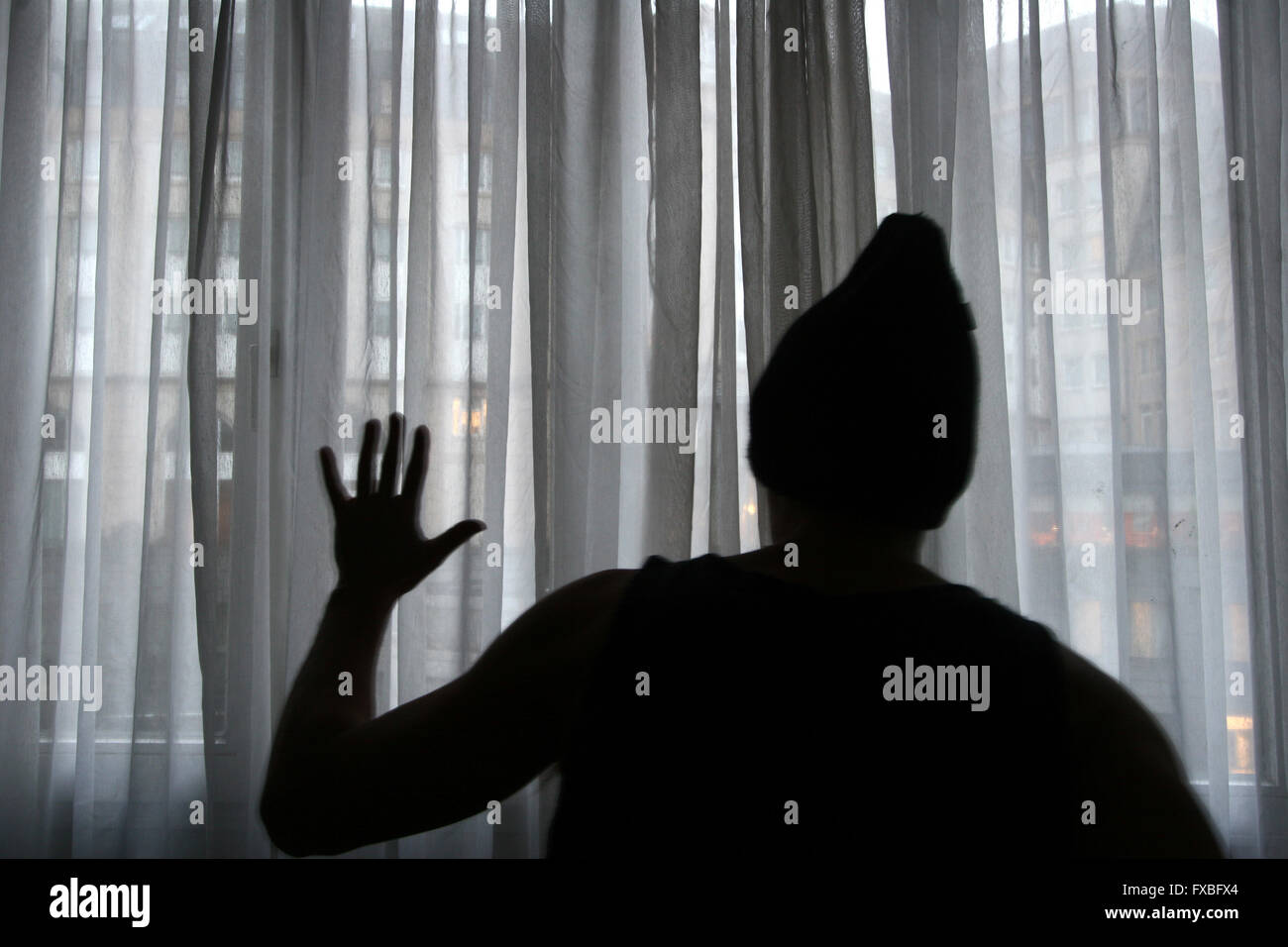 man shot against the light of a window (slow shutter speed, the man ...