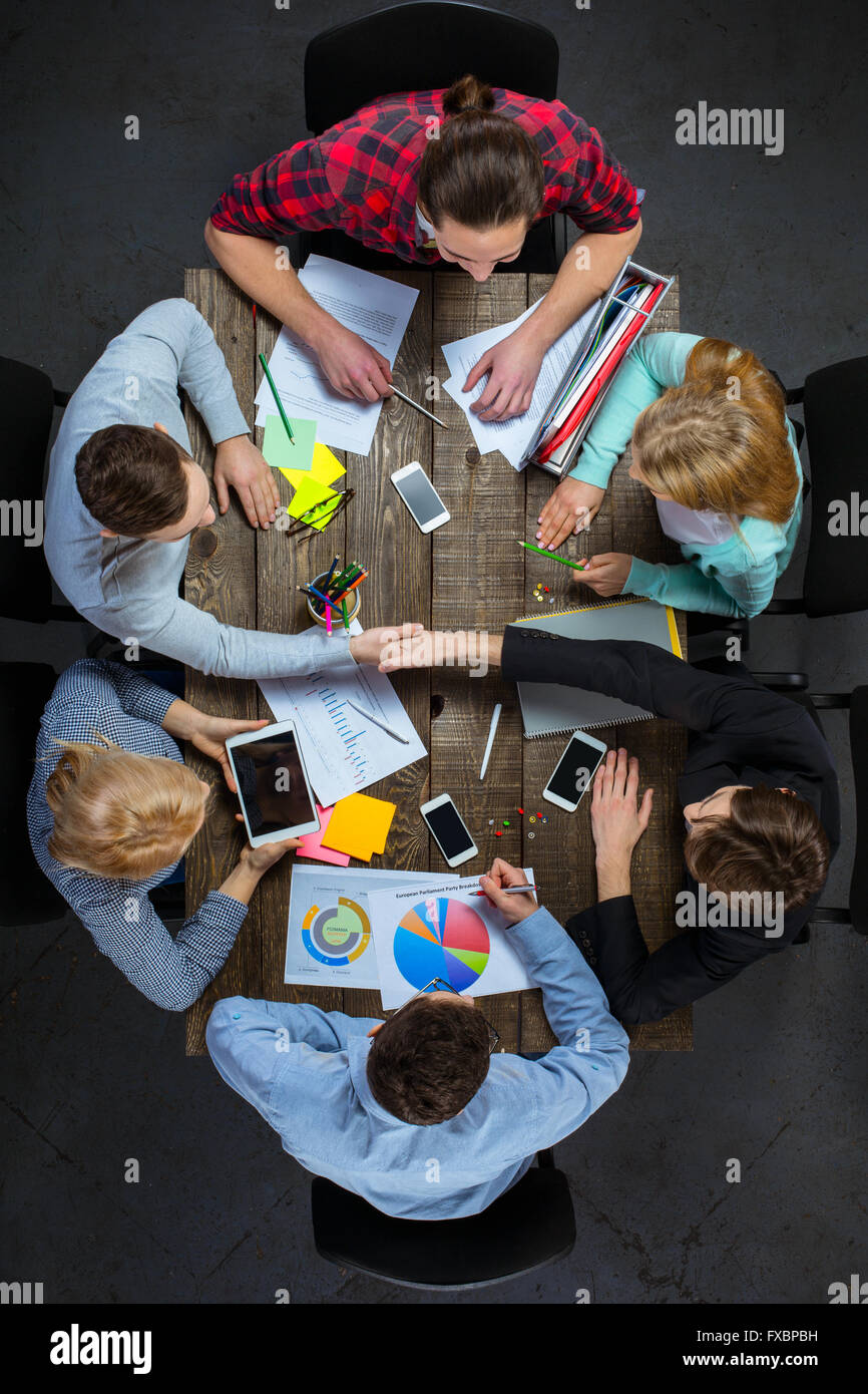 Top view of business people at wooden table Stock Photo - Alamy