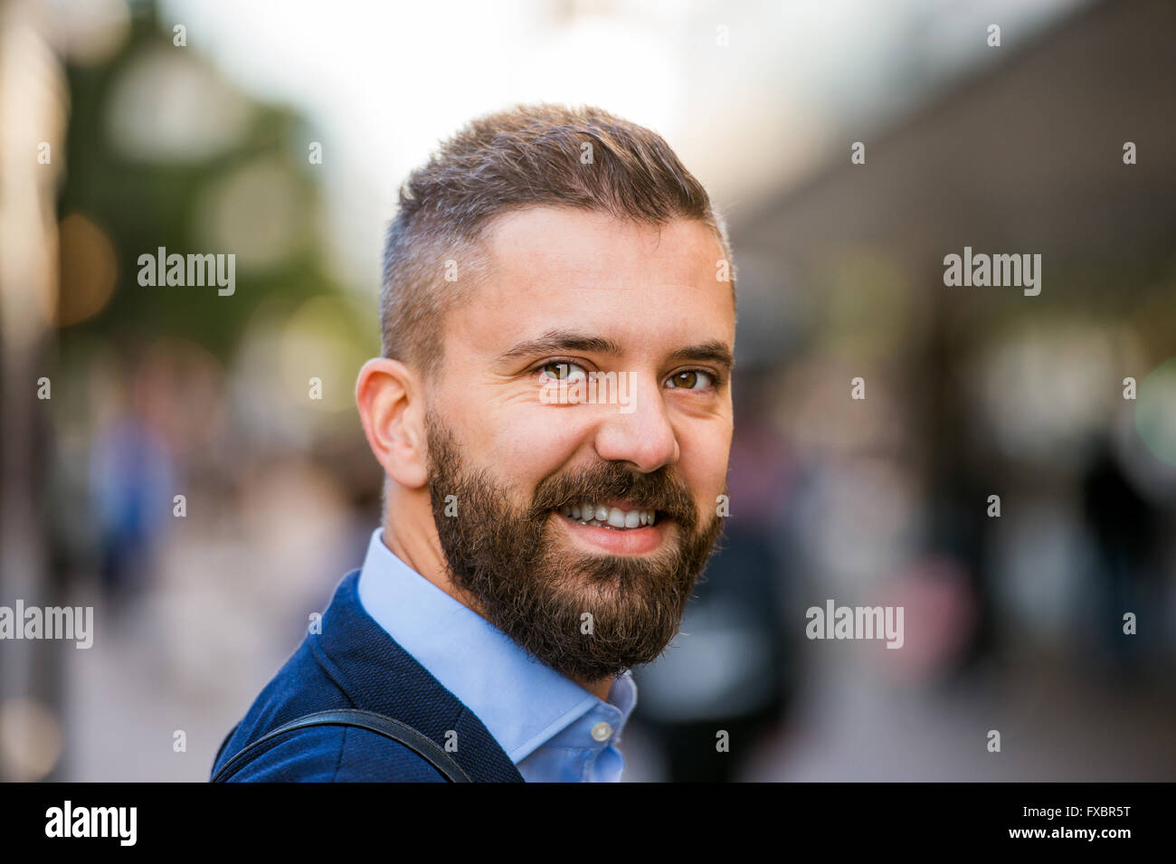 Hipster manager in blue shirt walking in the street Stock Photo - Alamy