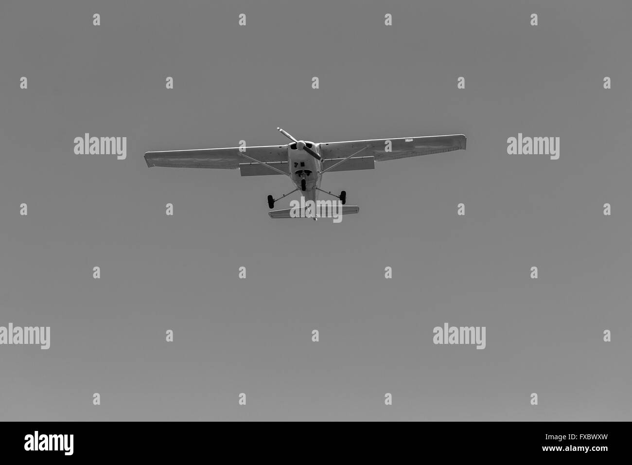 Plane flying light propellor aircraft two seater closeup upward sky ...