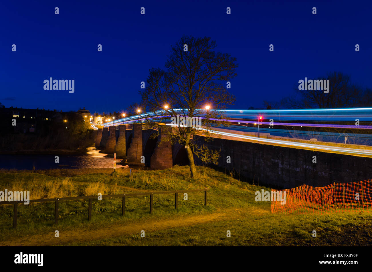A Night Time Long Exposure Photograph of the Bridge and Riverside at ...