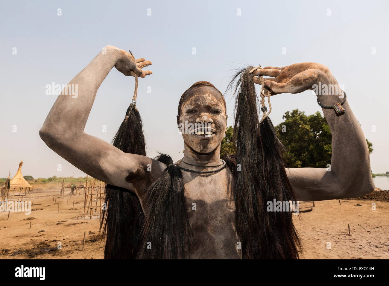 South Sudan. 21st Feb, 2016. Covered in ash, a Mundari man displays the ...