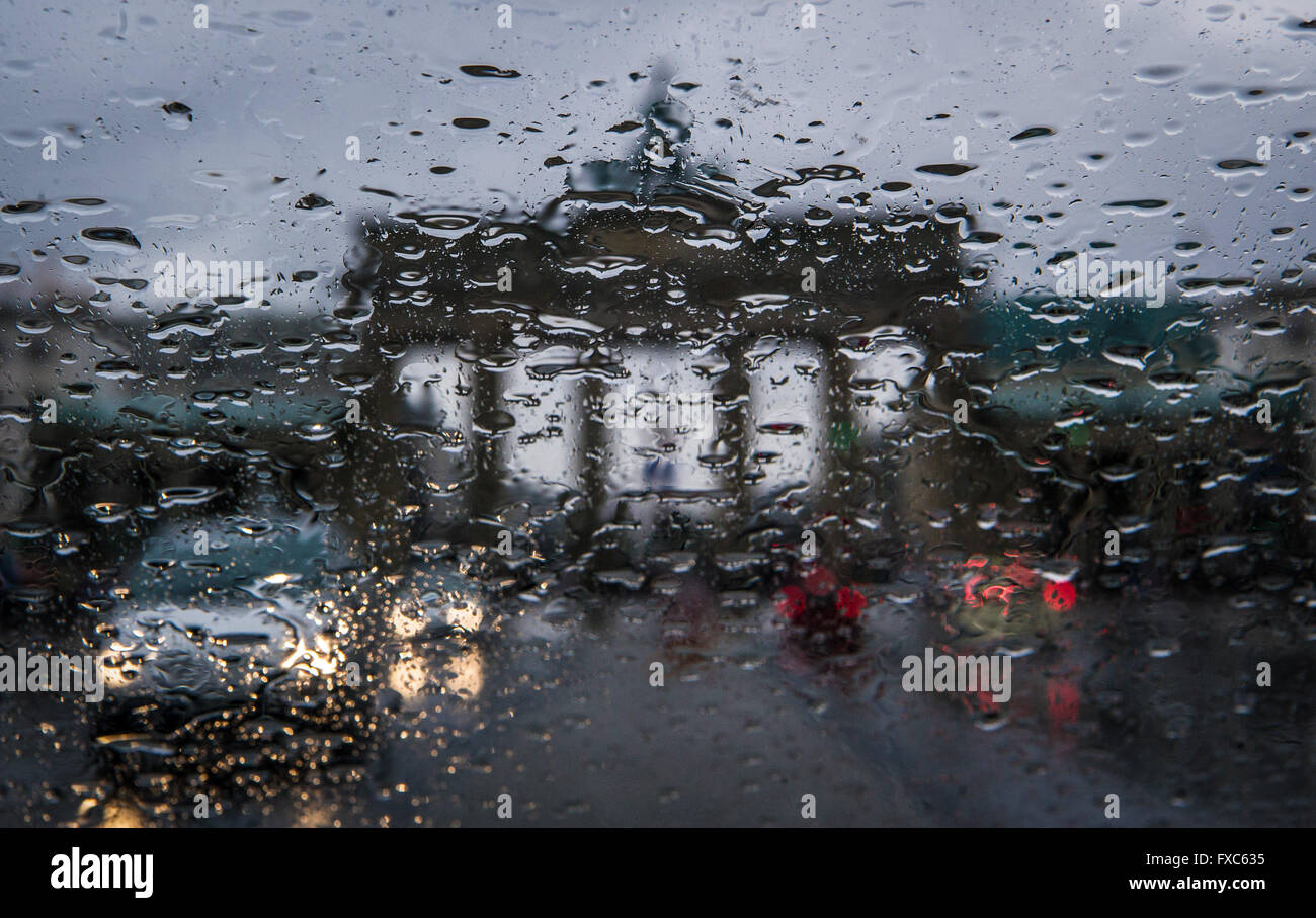 The Brandenburg Gate can be seen through a car windshield covered in ...