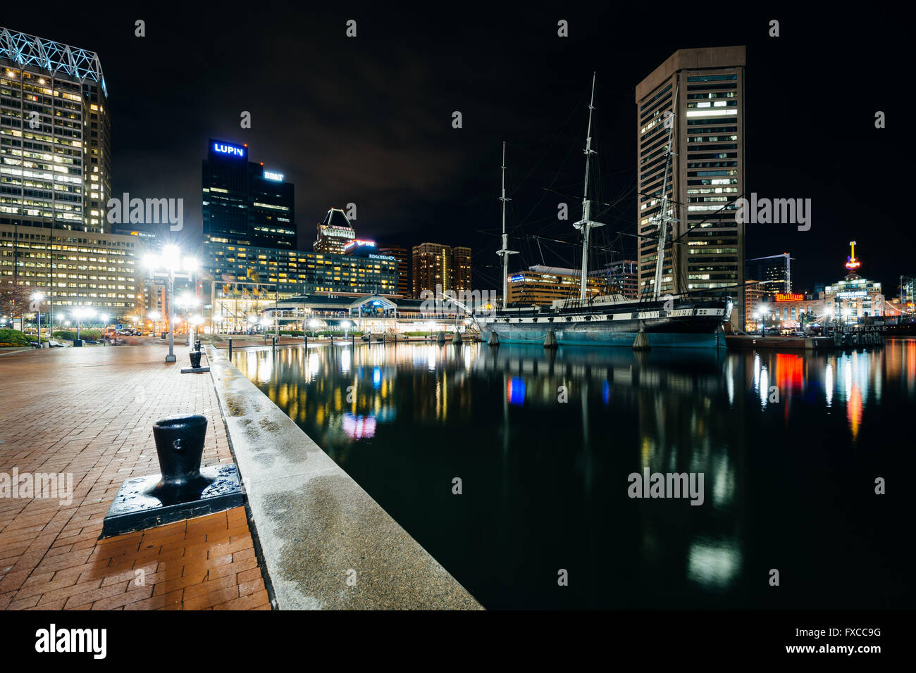 Waterfront promenade and modern buildings at night, at the Inner Harbor ...
